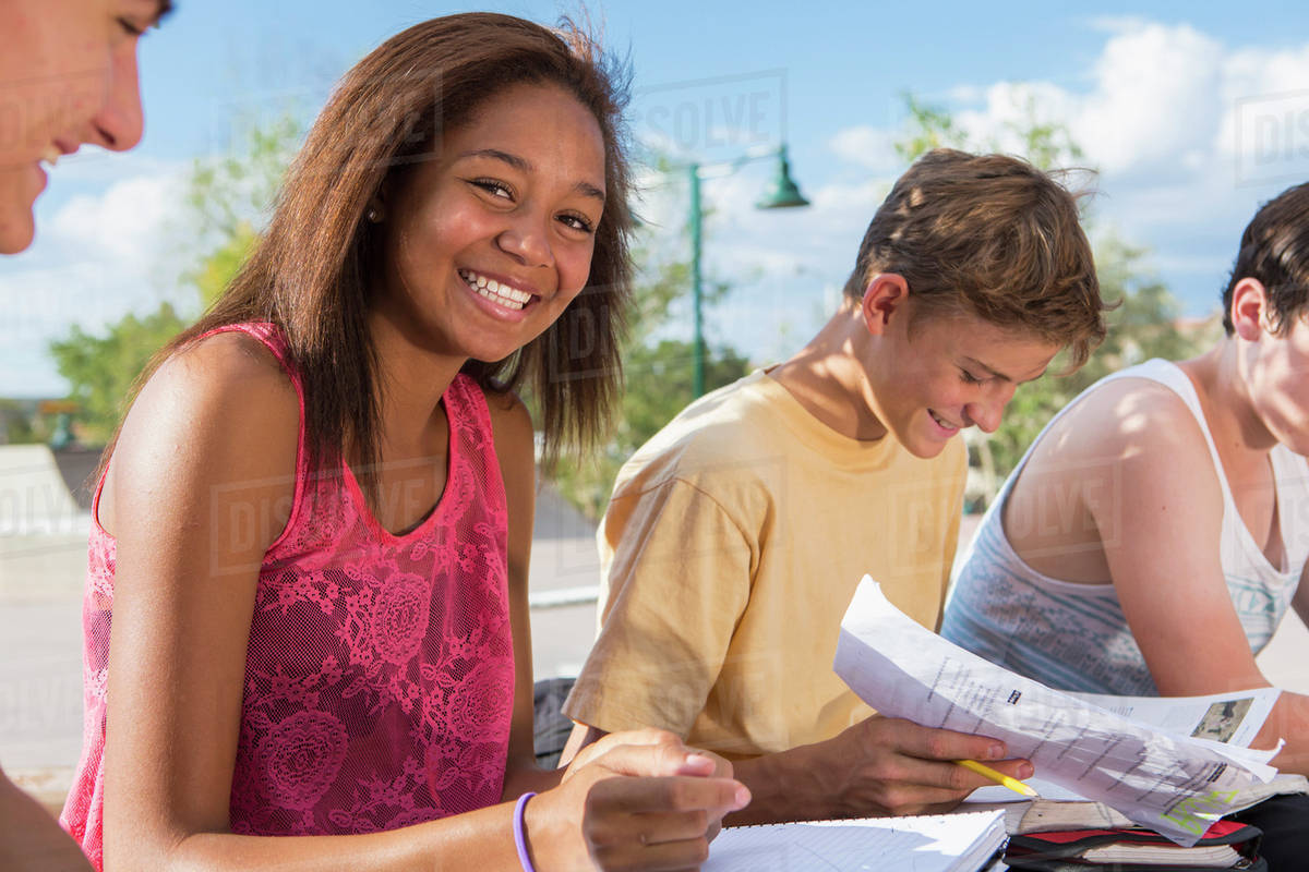 Teenagers doing homework together outdoors - Royalty-free Stock Photo ...