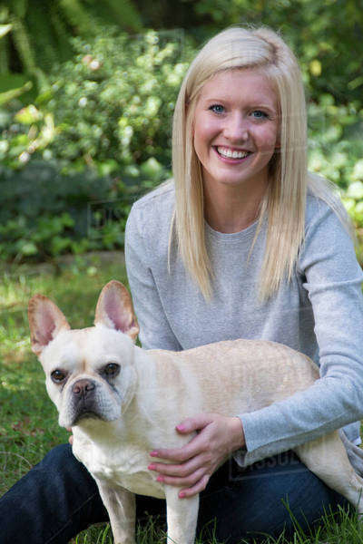 Caucasian woman petting dog outdoors - Royalty-free Stock Photo | Dissolve