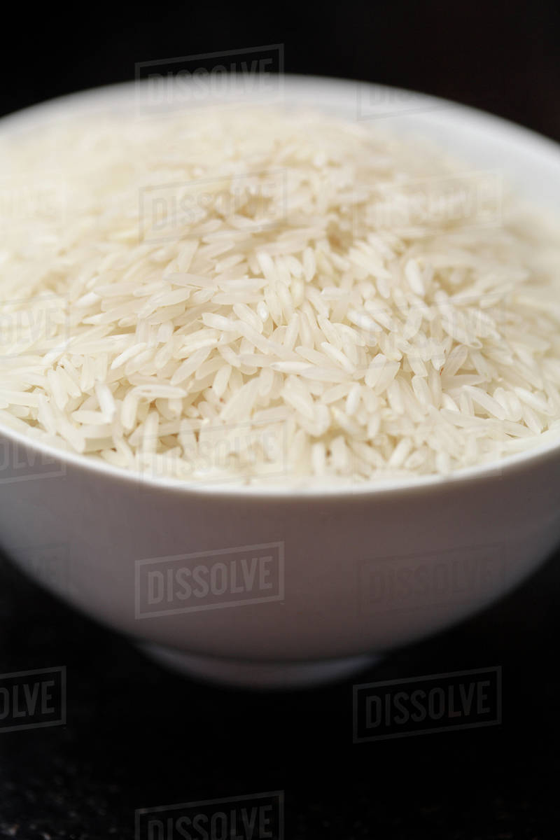 Uncooked rice in bowl - Royalty-free Stock Photo | Dissolve