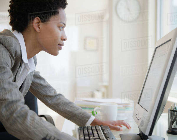 African American woman using computer - Royalty-free Stock Photo | Dissolve