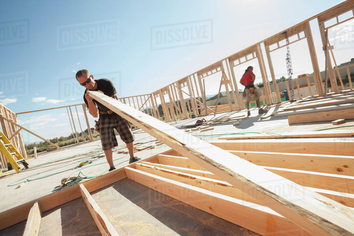 Caucasian man working on frame on construction site - Royalty-free ...