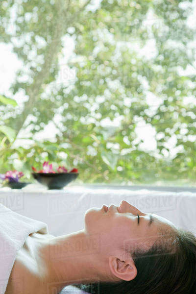 Chinese woman relaxing in spa - Stock Photo - Dissolve