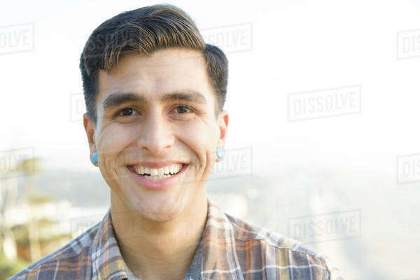 Smiling man standing outdoors - Royalty-free Stock Photo | Dissolve