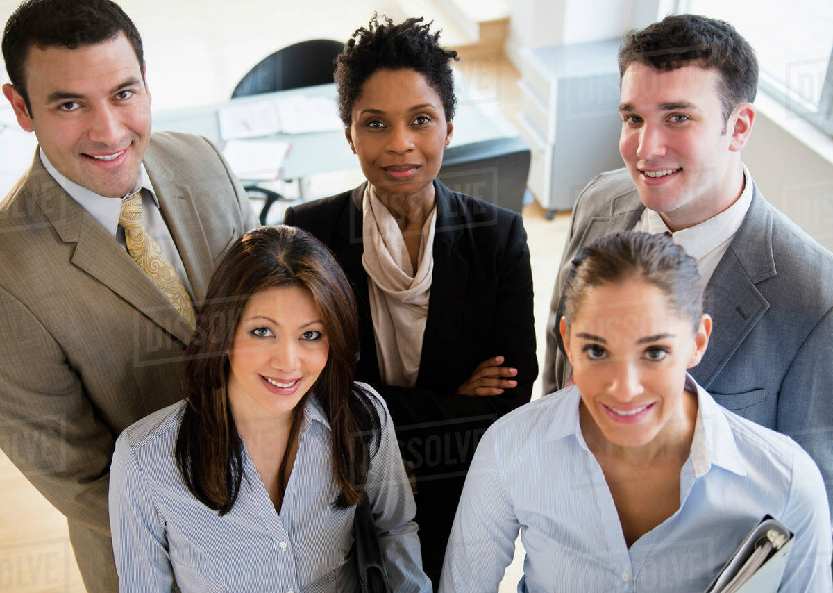 Business people smiling together in office - Royalty-free Stock Photo ...