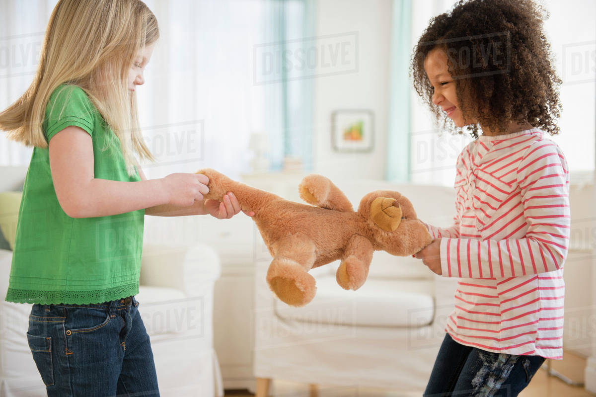Girls fighting over teddy bear in living room - Royalty-free Stock ...