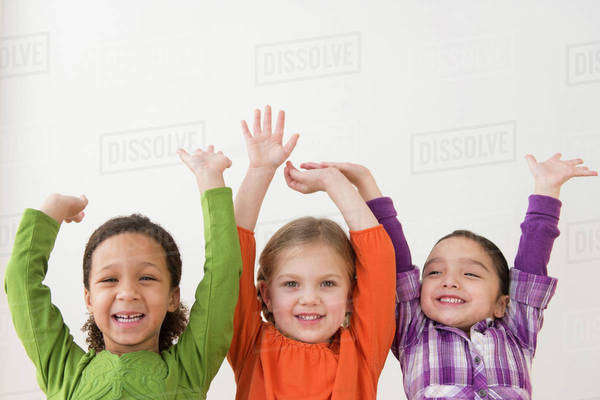 Smiling girls cheering together - Royalty-free Stock Photo | Dissolve