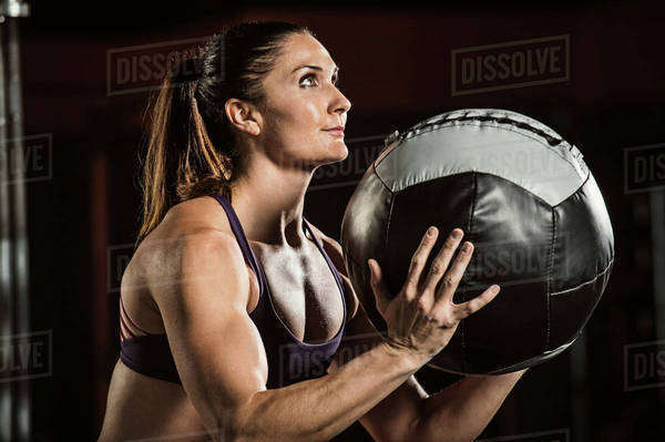 Caucasian athlete lifting resistance ball in gym - Royalty-free Stock ...