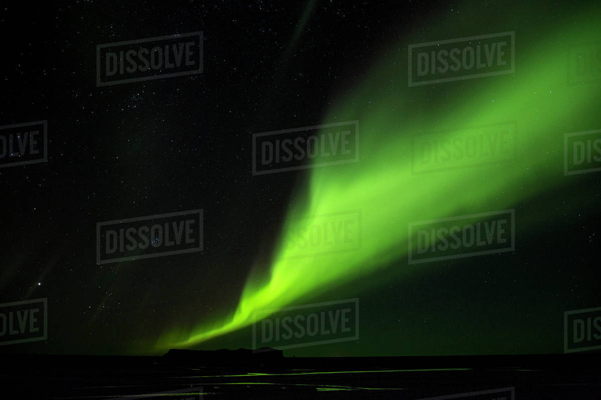 Northern Lights glowing green in night sky - Royalty-free Stock Photo ...