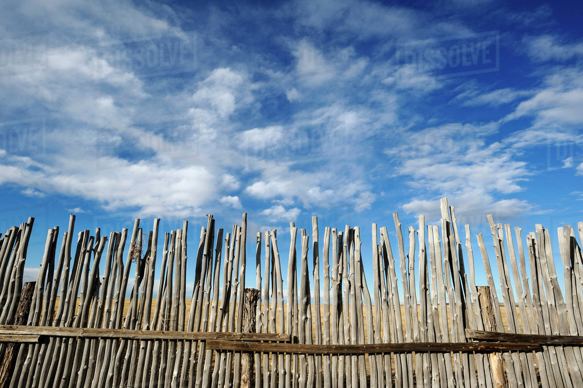 Low angle view of rustic corral fence under blue sky - Royalty-free ...