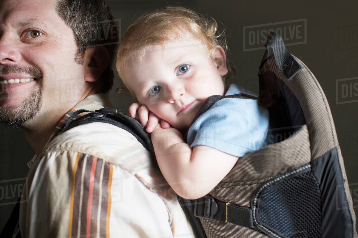 Caucasian father carrying son on back - Royalty-free Stock Photo | Dissolve
