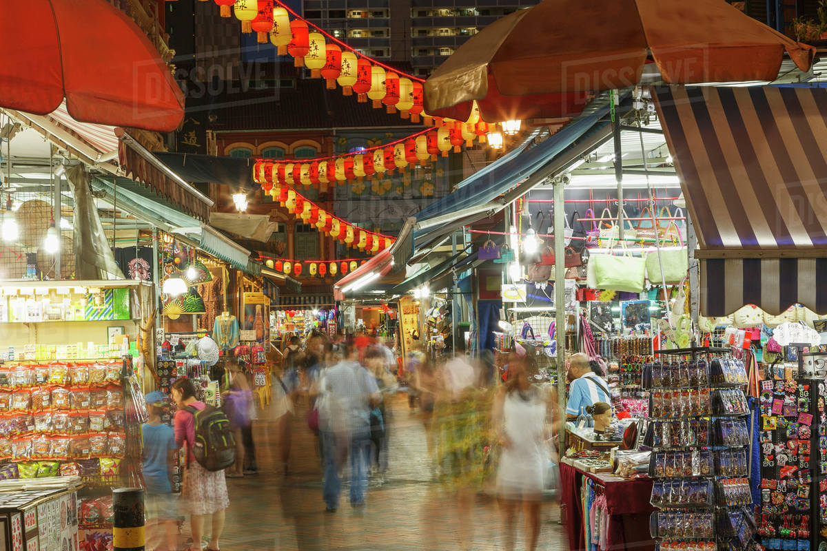 Blurred view of people shopping in outdoor market at night - Royalty ...