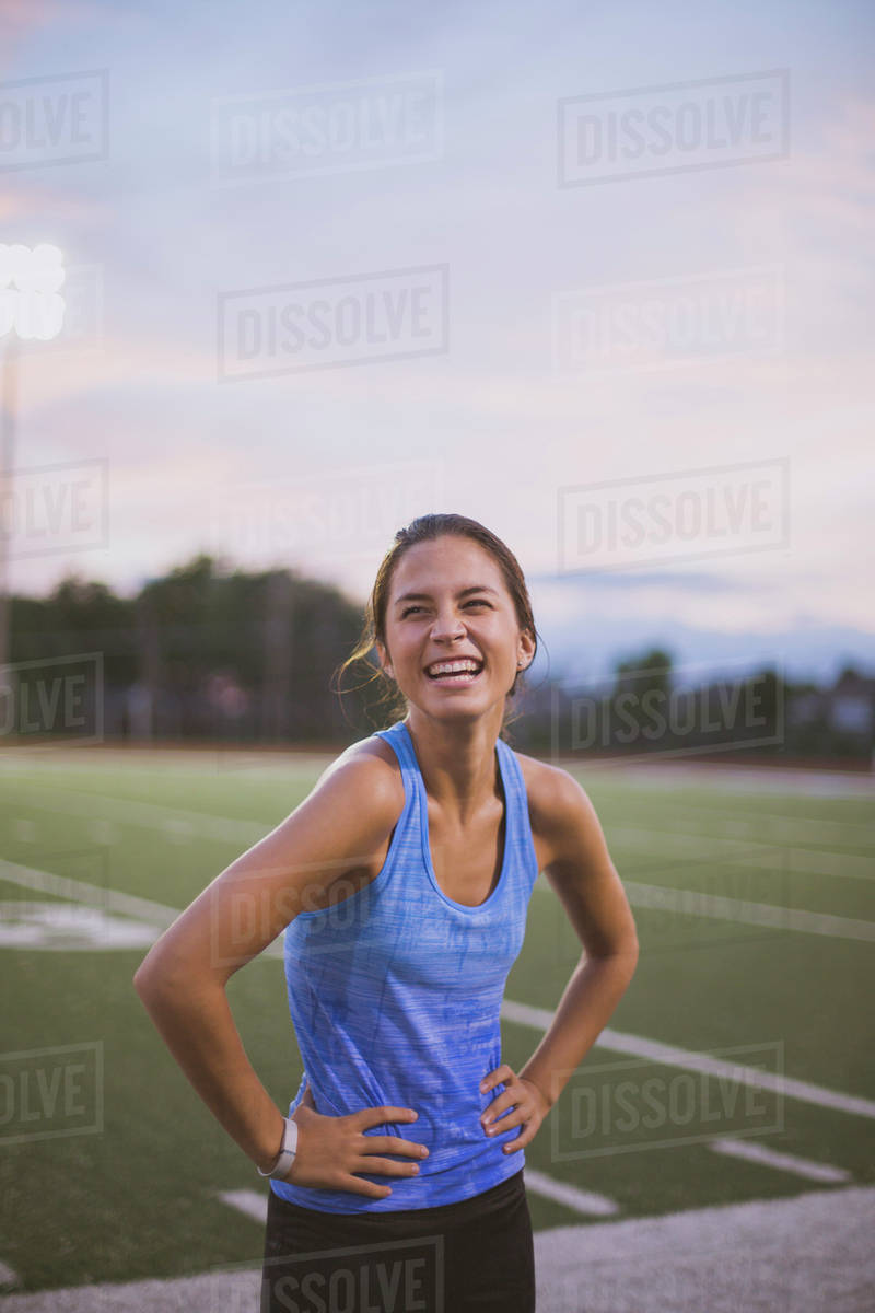 Mixed race athlete laughing on sports field - Royalty-free Stock Photo ...