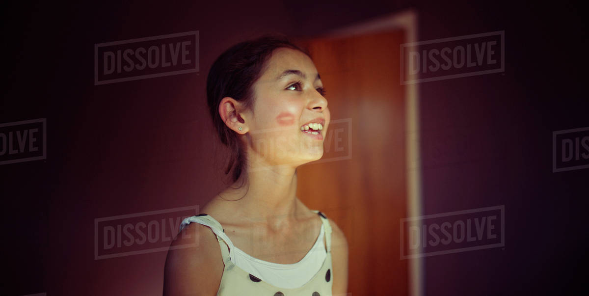 Mixed race girl with lipstick kiss on cheek - Royalty-free Stock Photo ...