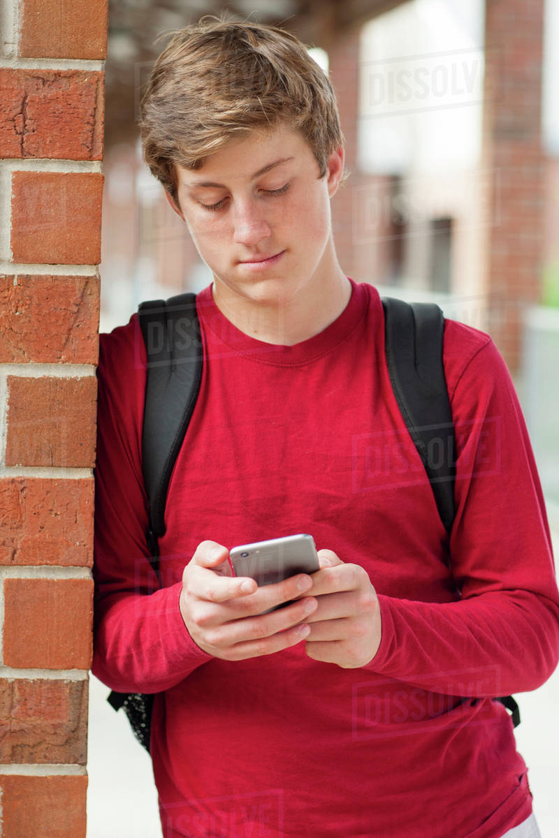 Caucasian teenage boy using cell phone - Royalty-free Stock Photo ...