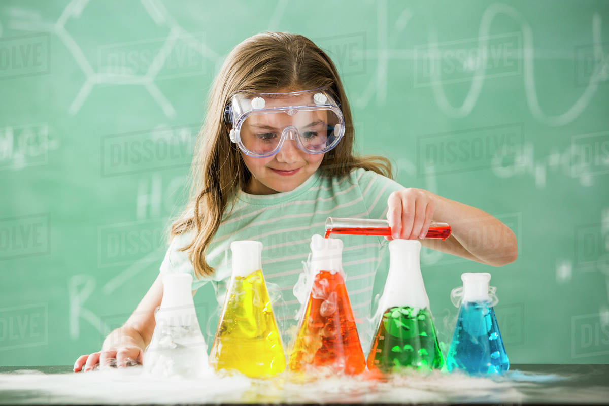 Caucasian girl doing science experiment in classroom - Royalty-free ...