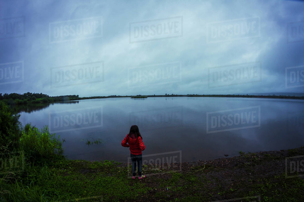 Caucasian teenage girl standing by remote lake - Royalty-free Stock ...