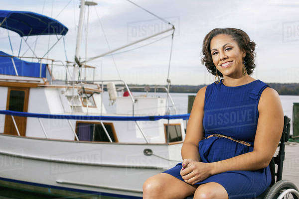 Disabled woman smiling in wheelchair on harbor - Royalty-free Stock ...