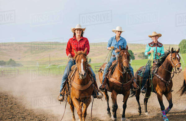 Cowgirls riding horses on ranch - Royalty-free Stock Photo | Dissolve