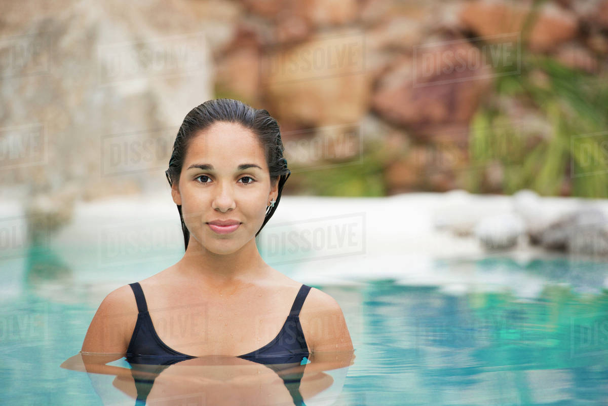 Hispanic woman swimming in pool - Royalty-free Stock Photo | Dissolve