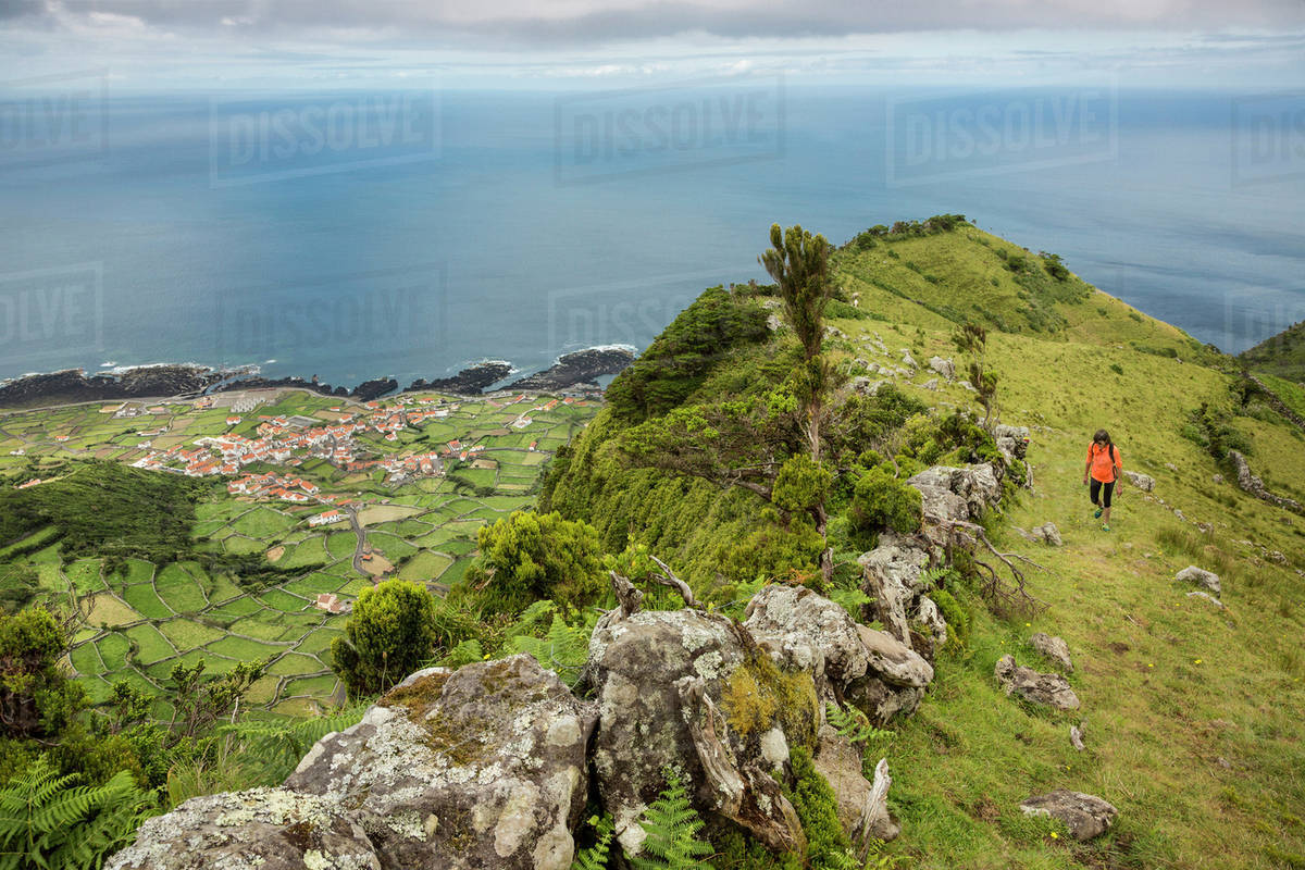 Hiker walking on hilltop path in rural landscape - Royalty-free Stock ...