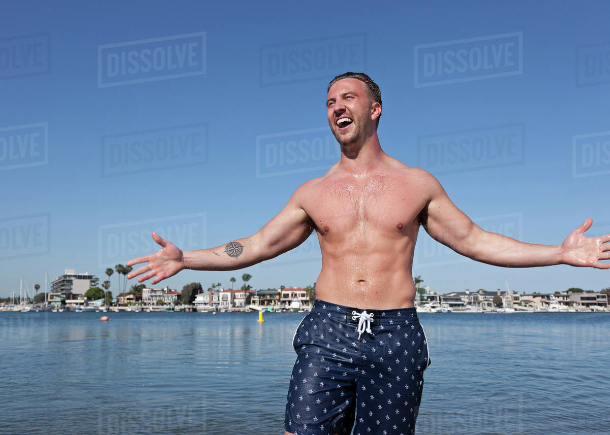 Caucasian man wearing swimsuit on beach - Royalty-free Stock Photo ...