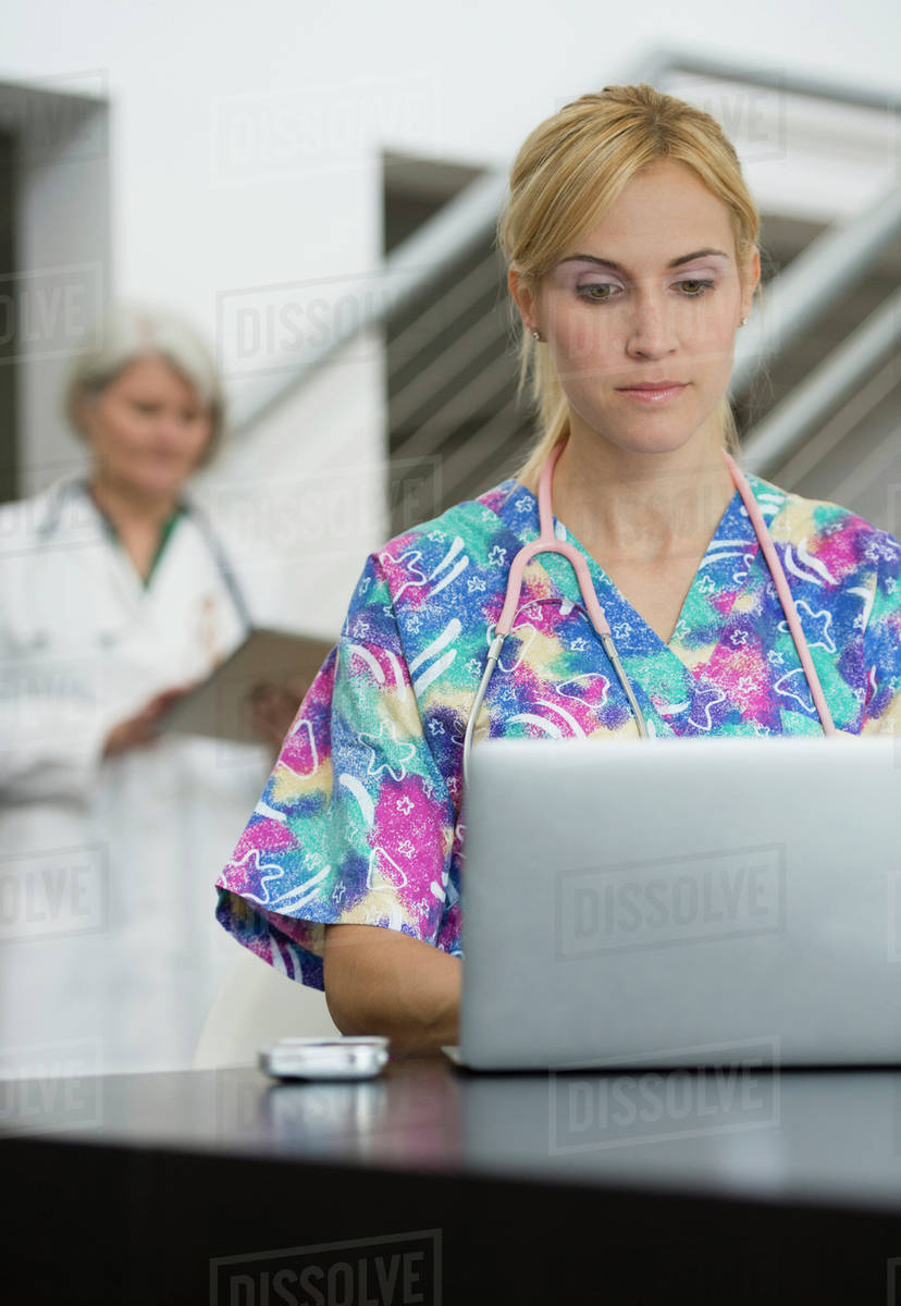 Caucasian nurse using laptop - Royalty-free Stock Photo | Dissolve