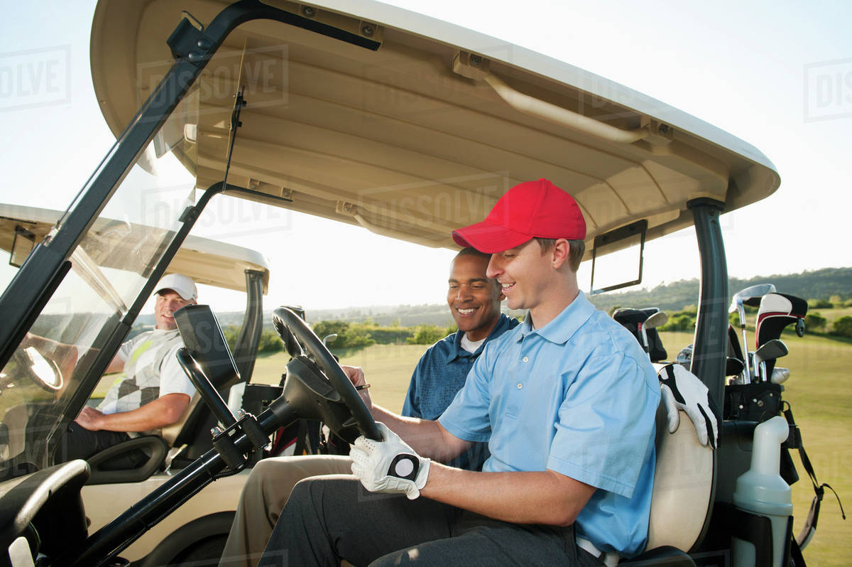 Men driving golf carts on golf course - Royalty-free Stock Photo | Dissolve