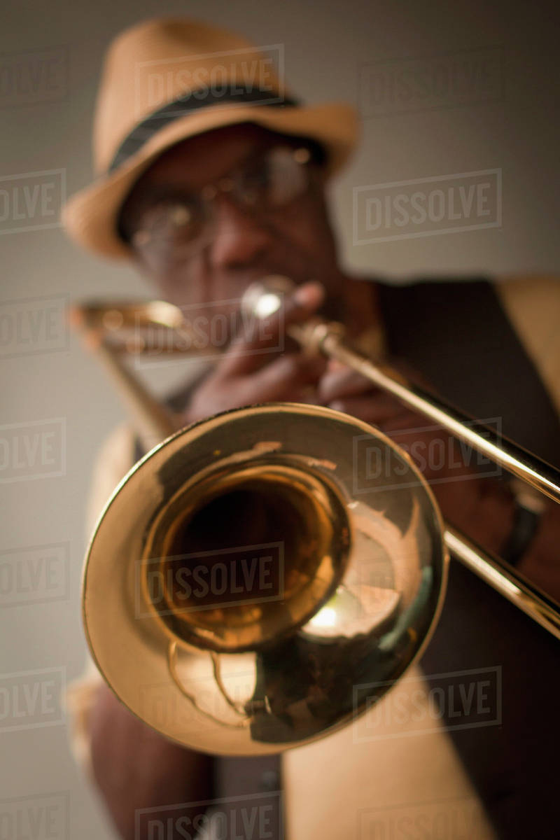 African American musician playing trombone - Stock Photo - Dissolve