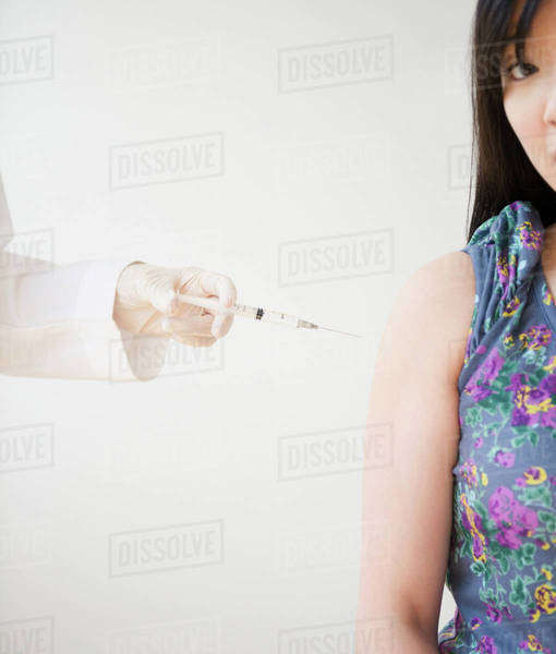 Korean woman receiving injection - Royalty-free Stock Photo | Dissolve
