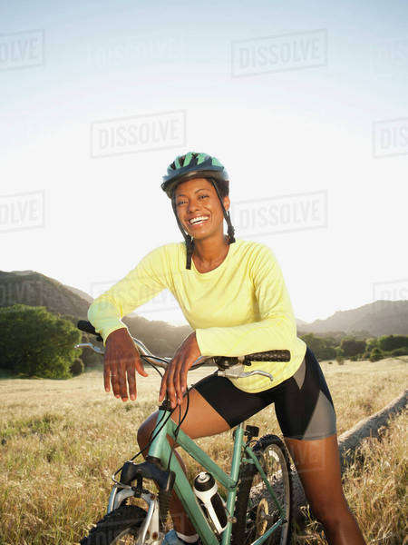 Mixed race biker standing with mountain bike - Royalty-free Stock Photo ...