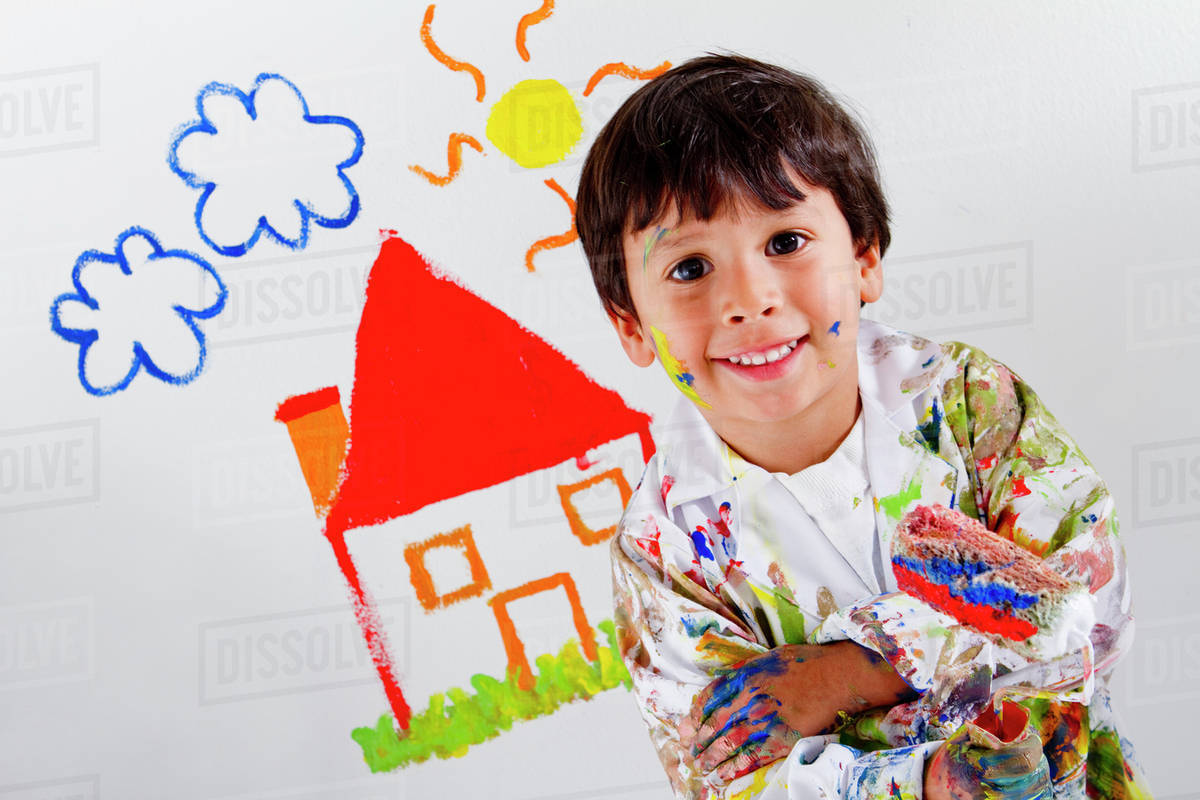 Hispanic boy painting - Royalty-free Stock Photo | Dissolve