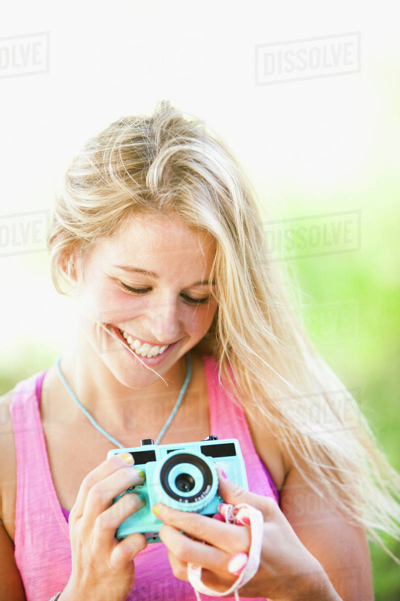 Caucasian woman holding camera - Royalty-free Stock Photo | Dissolve