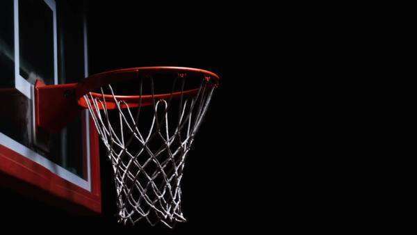 Close up of a basketball hitting the rim of the hoop and bouncing away ...
