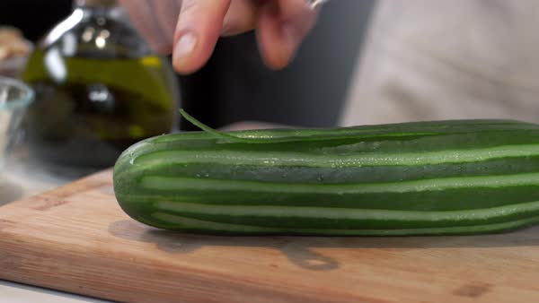 Close-up shot of chef scoring fresh cucumber - Stock Video Footage ...