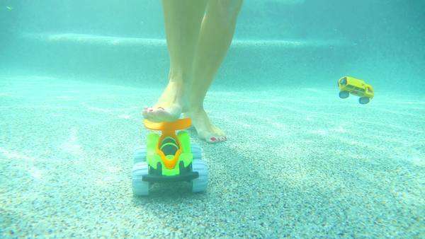 Woman stumbles on toys walking on the bottom of a pool - 4K Royalty ...