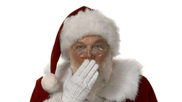 A close up of Santa standing and blowing a kiss on a white background ...