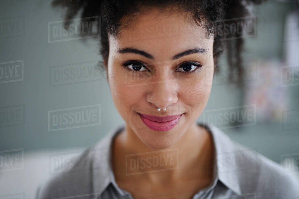 Close-up front view portrait of beautiful young woman indoors, looking ...