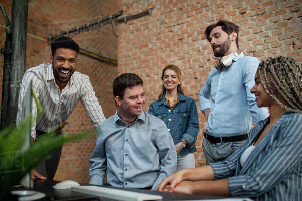 Cheerful young businesspeople having fun in a office, social inclusion ...