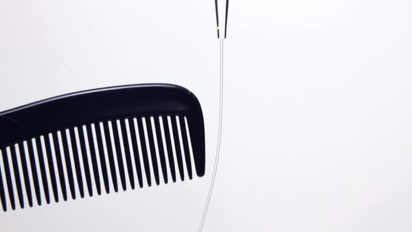 Charged comb deflects water stream. After a plastic comb is used for ...