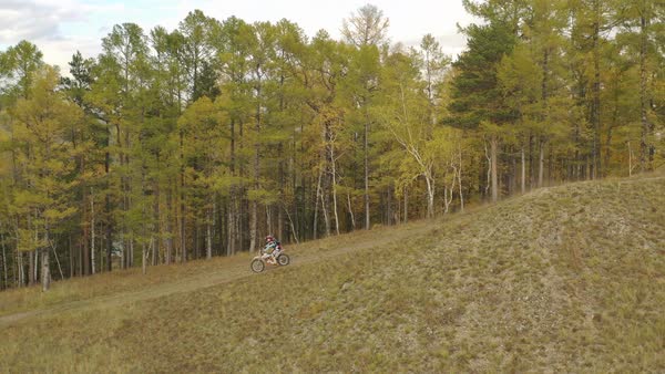 Aerial view of a man on a motorcycle riding down a mountain. - Stock ...