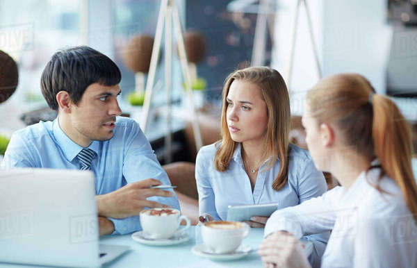 Businessman sharing ideas with his colleagues - Stock Photo - Dissolve