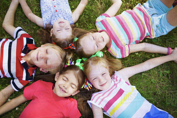 Relaxing kids with closed eyes lying on ground - Royalty-free Stock ...