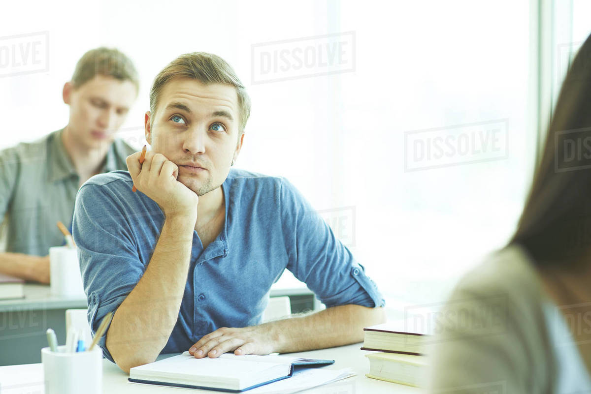 Pensive student with pencil sitting at lesson in college - Royalty-free ...