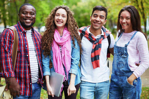 Portrait of happy college students standing together outdoors - Royalty ...