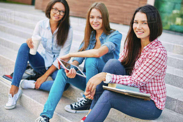 Portrait of high school students sitting on stairs outdoors - Royalty ...