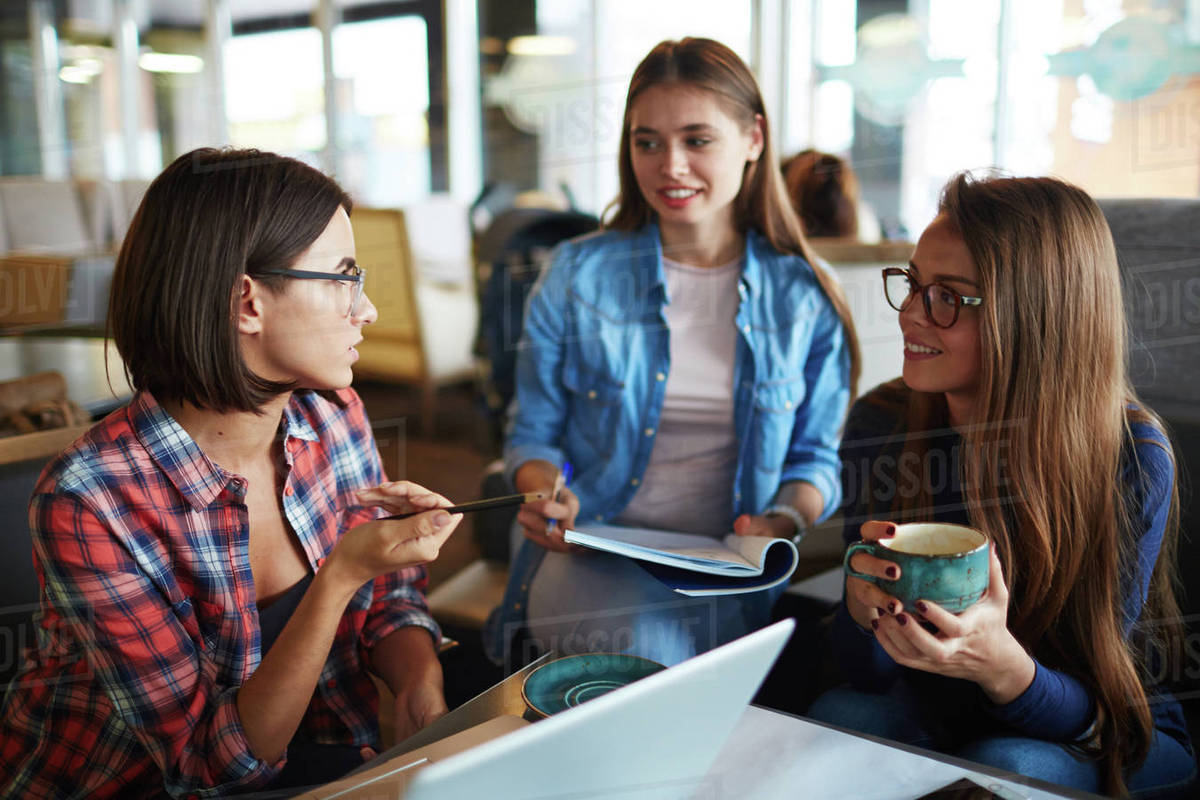 Three friendly students interacting after college classes - Royalty ...