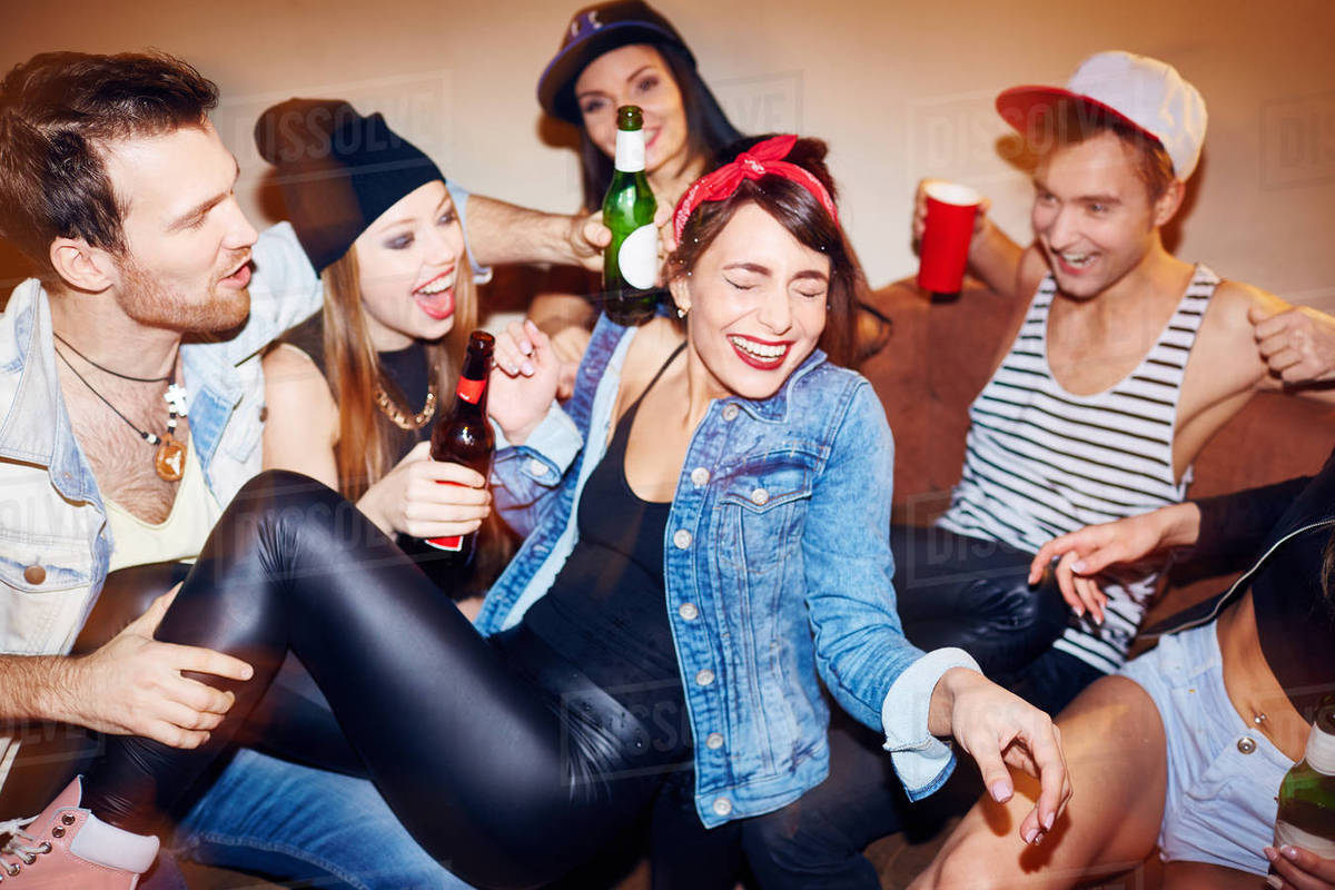 Laughing friends having fun at party - Stock Photo - Dissolve