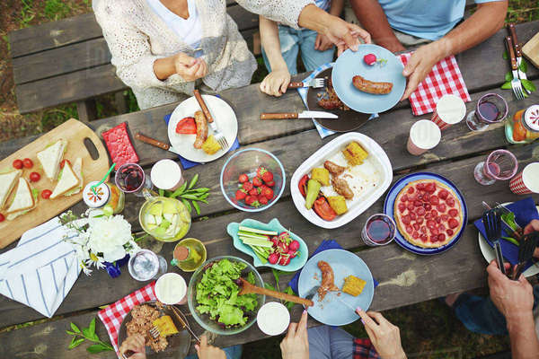 Hands of humans eating tasty food - Royalty-free Stock Photo | Dissolve