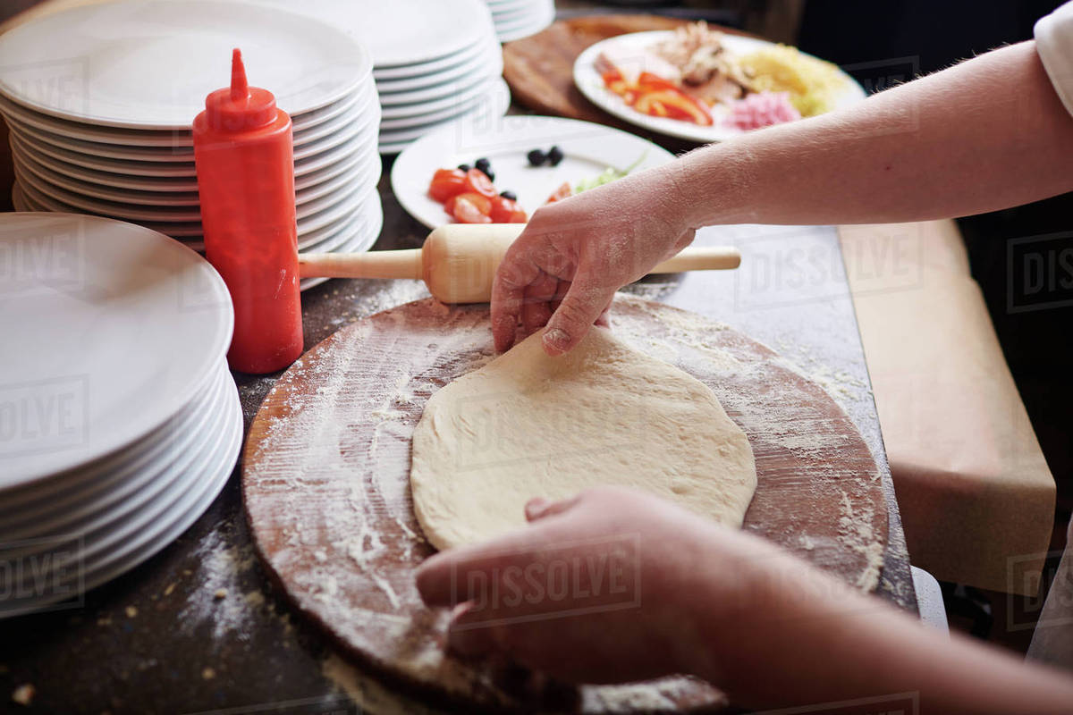 Chef making flat-bread for pizza - Stock Photo - Dissolve