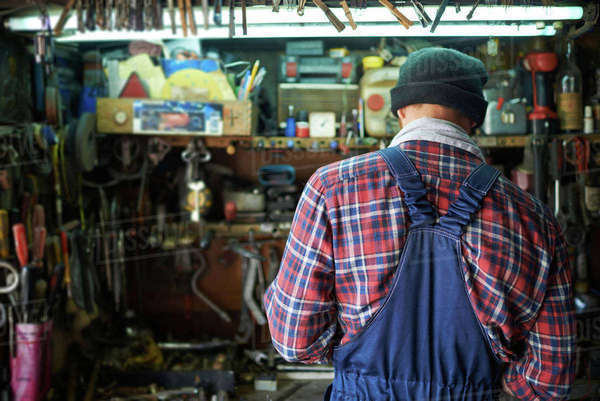 Rear view of worker at workshop - Royalty-free Stock Photo | Dissolve